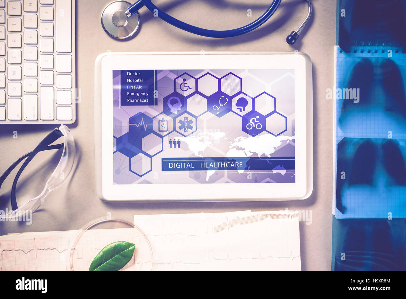 White tablet pc and doctor tools on gray surface Stock Photo - Alamy