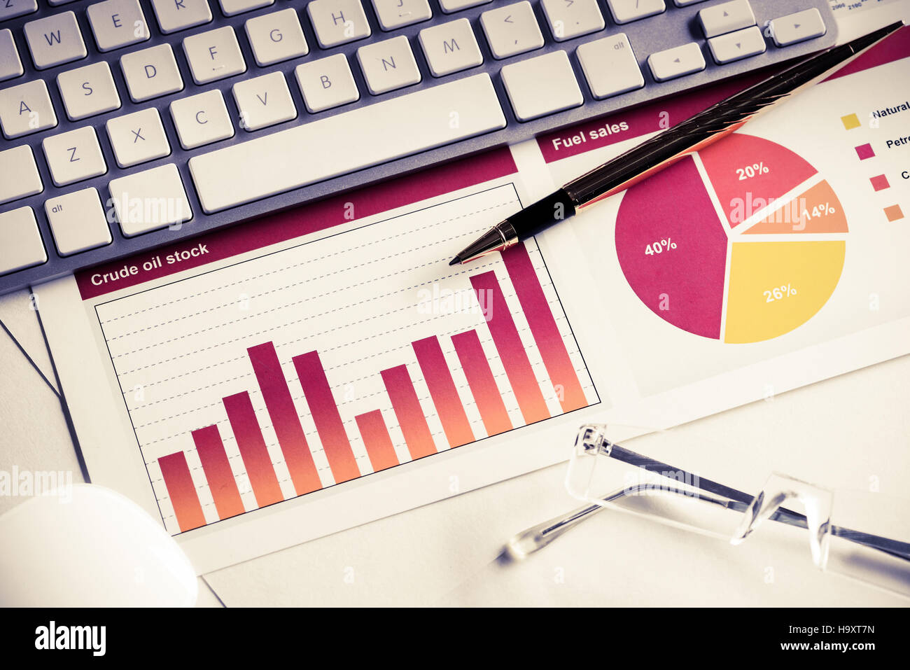 Business workplace with keyboard mouse and papers with graphs and ...