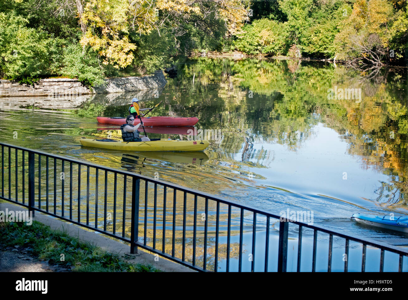 Man and woman quietly paddling kayaks through channel between Lake ...