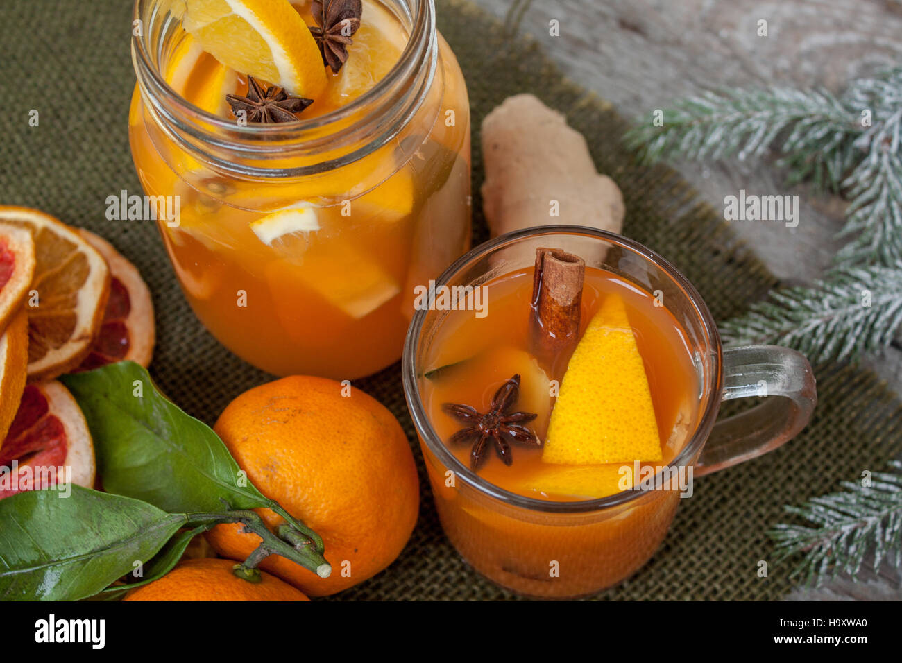 Winter healing ginger drink with lemon, honey and oranges. Cinnamon ...