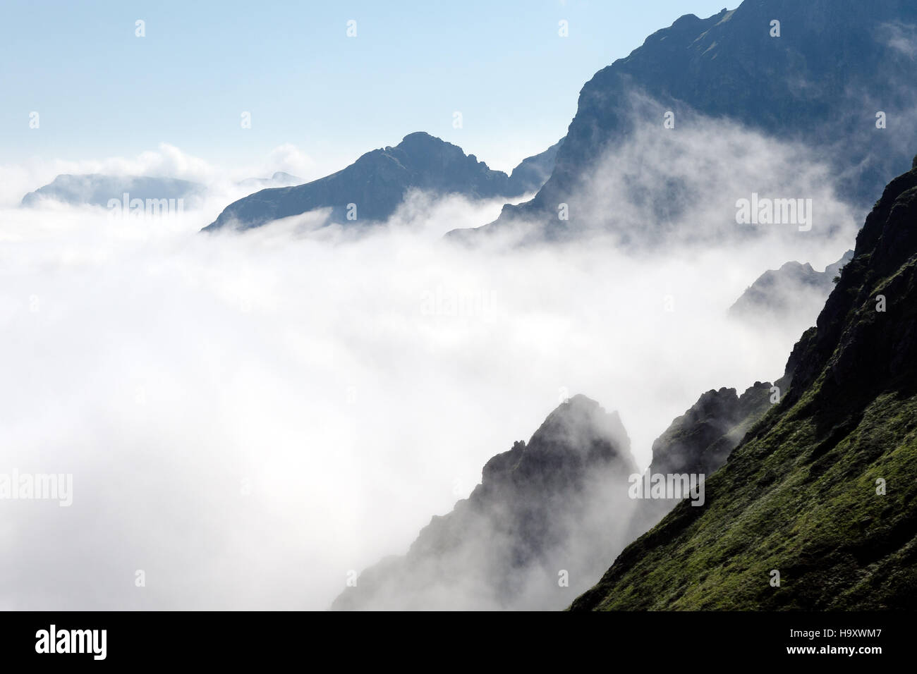 Steep mountain slopes and low clouds, temperature inversion effect ...