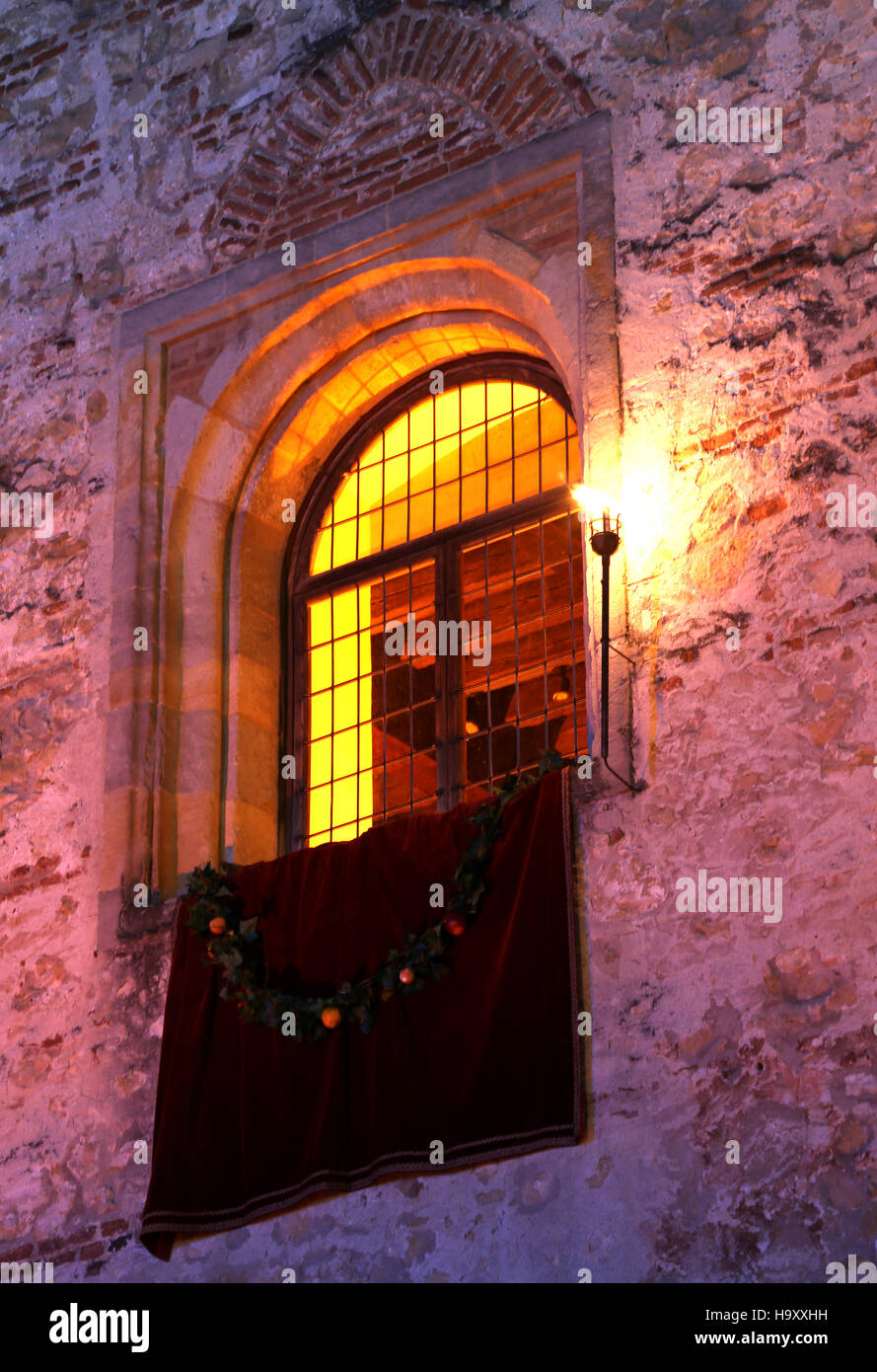 Windows of an ancient castle with torches at night Stock Photo - Alamy