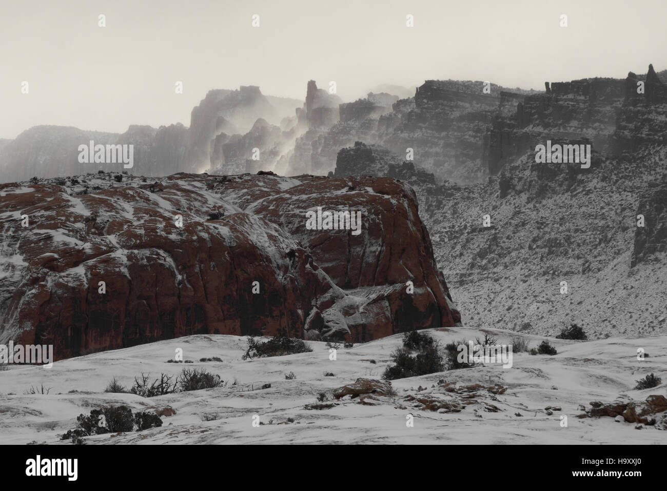 This image captures the dramatic scene of blowing snow on the Moab Rim ...