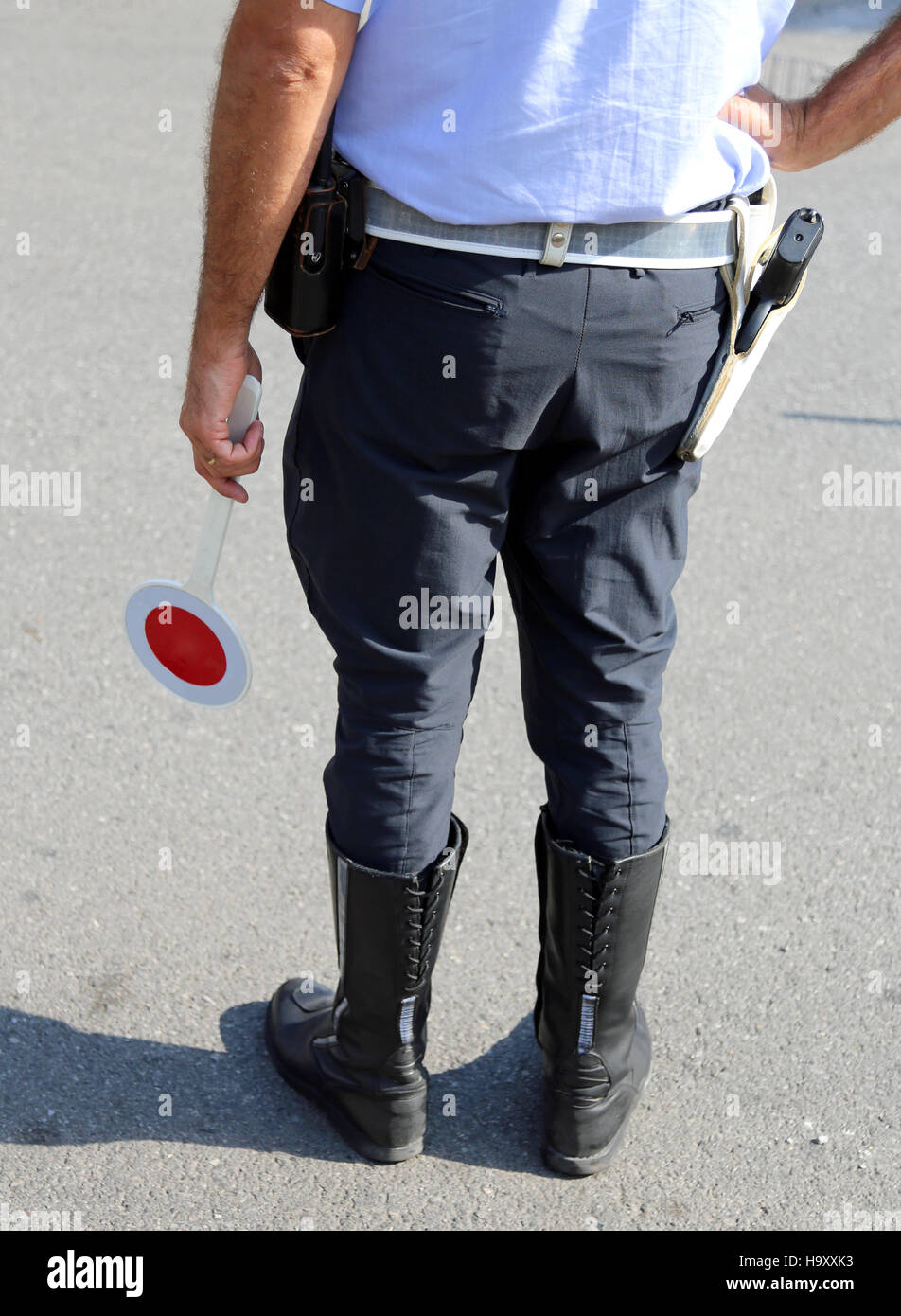 policeman with guns and paddle traffic on the street in checkpoint ...