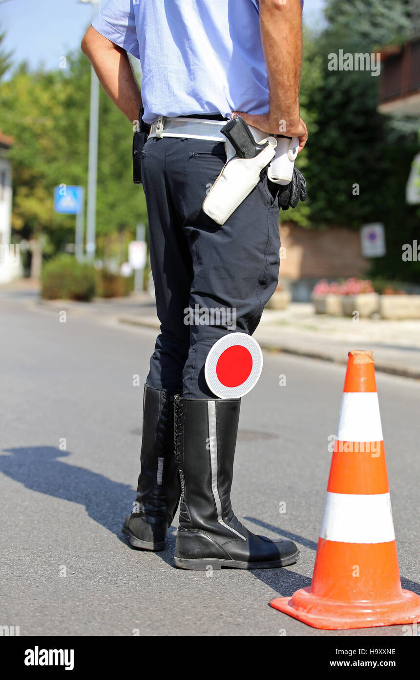 policeman in a checkpoint while checking motorists and a big traffic ...
