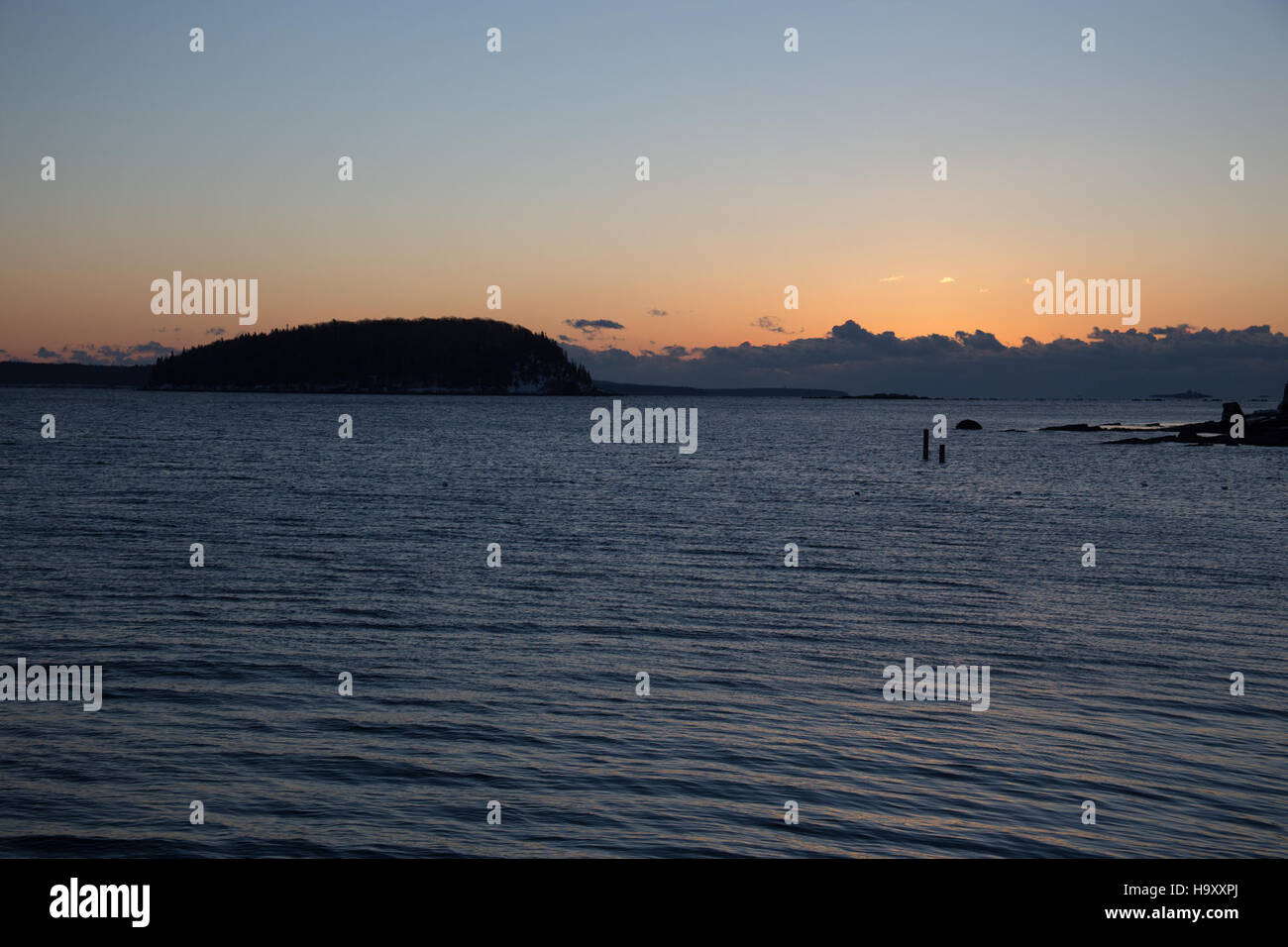A winter sunrise at Bar Harbor, with a view of Bar Island, captures the ...
