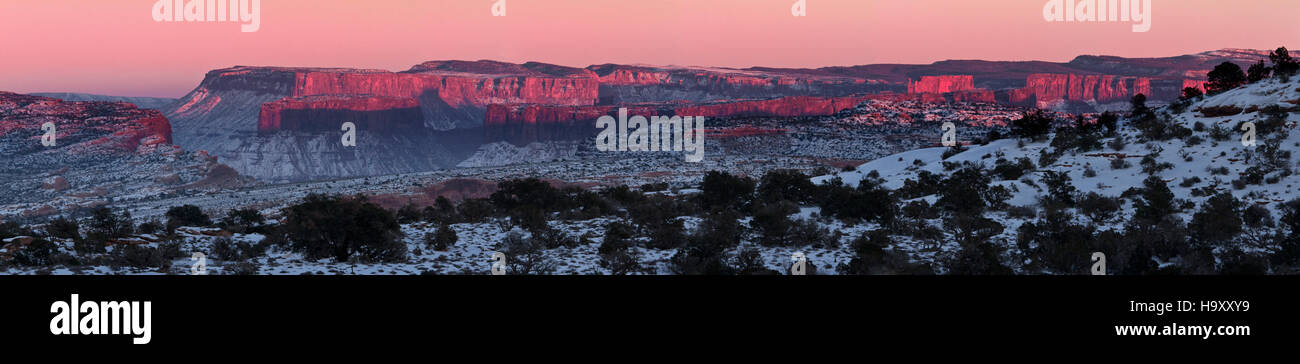 The Alpenglow on the cliffs of Arches National Park presents a stunning ...