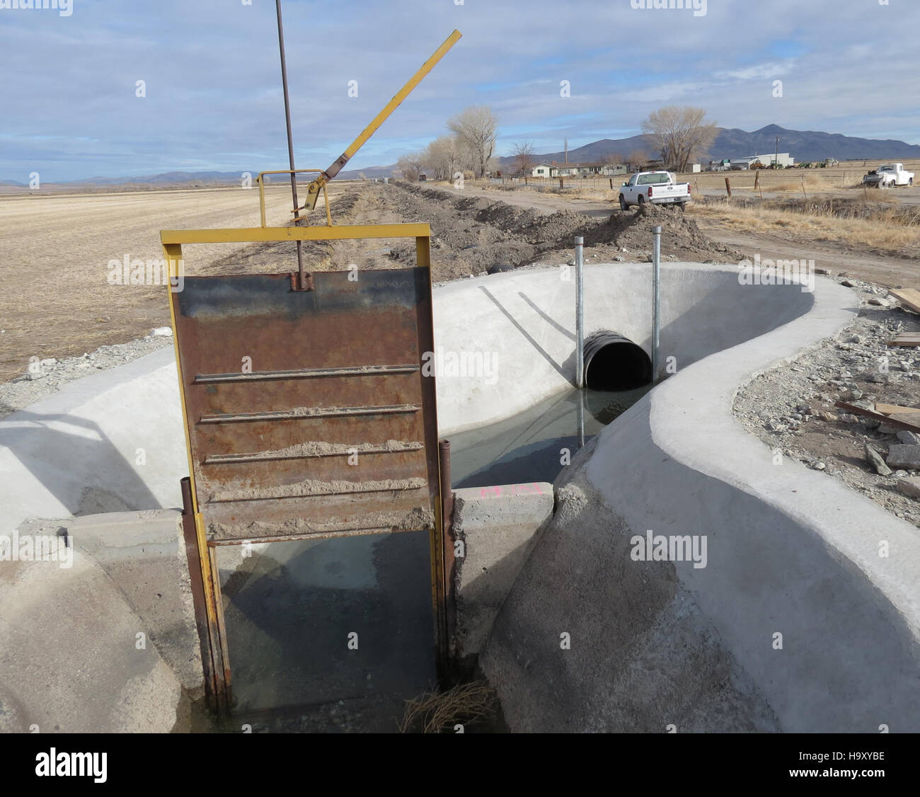 This image shows the installation of a water control structure in a ...
