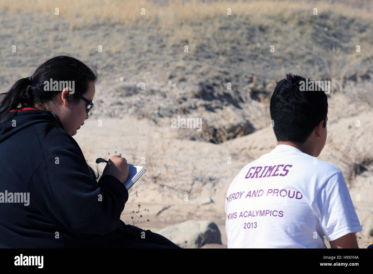 Two students document their observations in nature journals during a ...