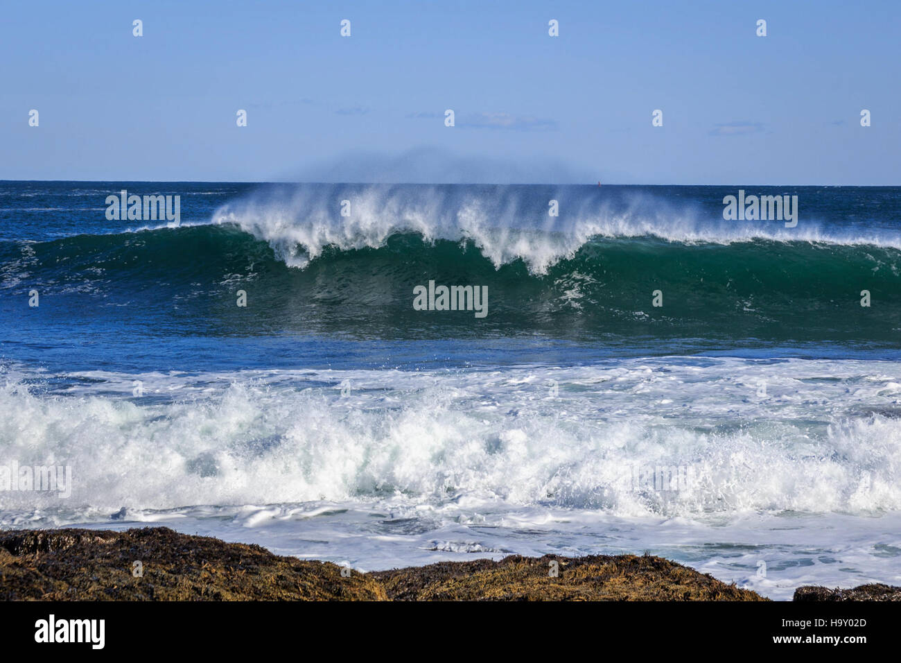 The crashing waves along the coastline are a powerful display of ...