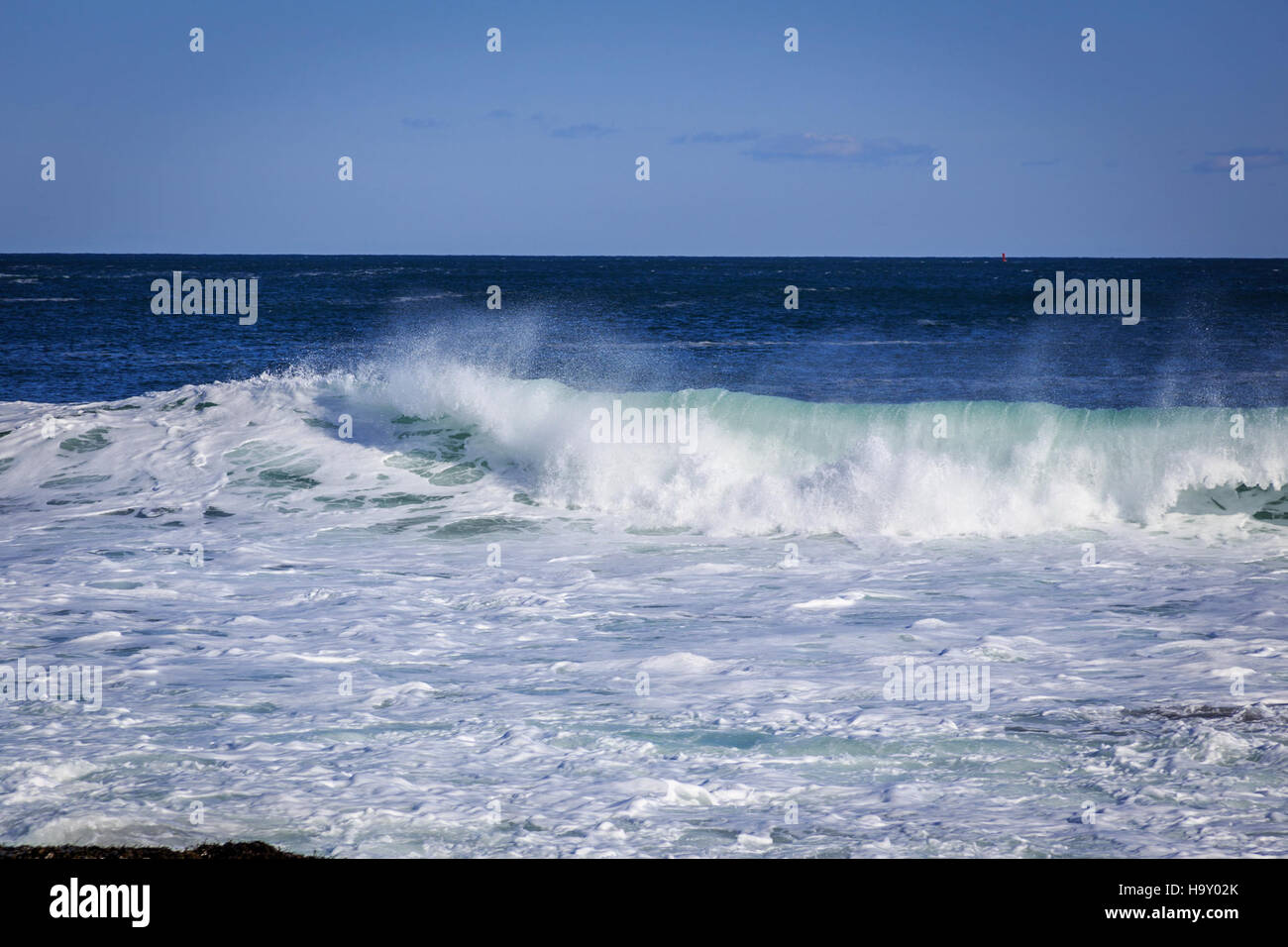 This image captures a dynamic wave pattern, likely in an oceanic environment. Waves are a ...