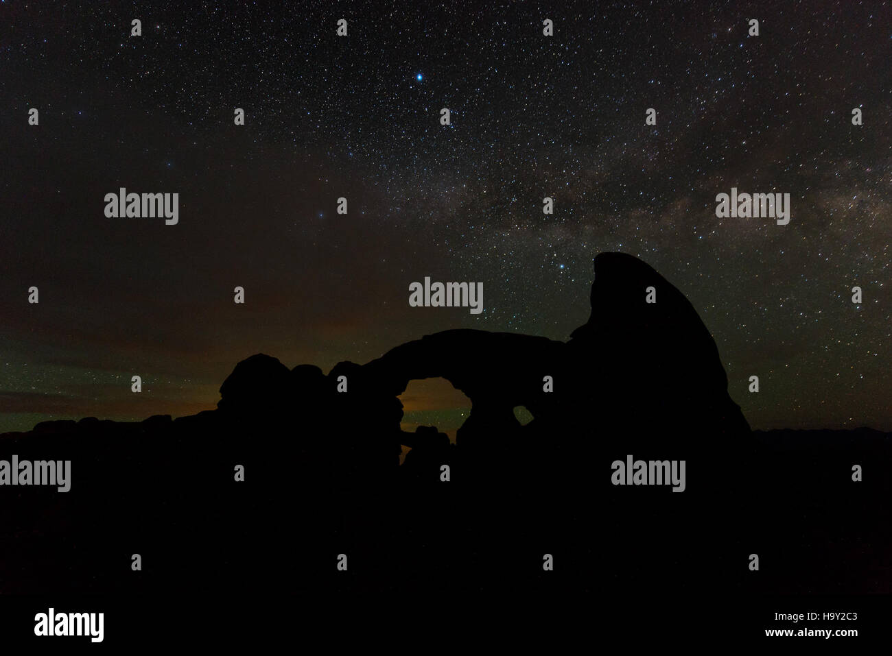 A stunning view of the night sky behind Turret Arch in Arches National ...