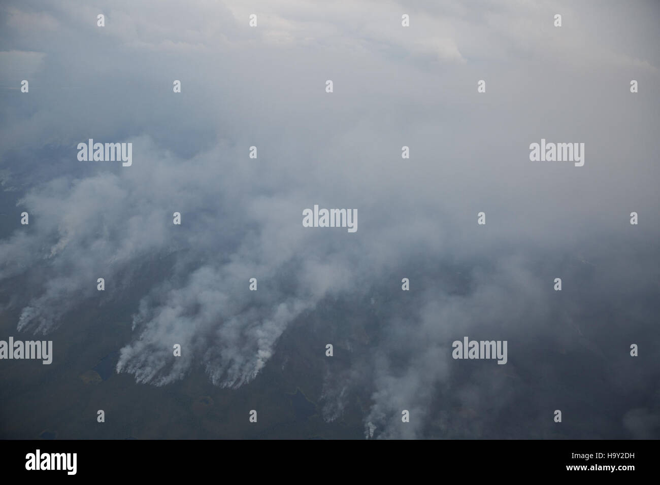 A helicopter flies over the Sandless Lake Fire in Denali National Park ...