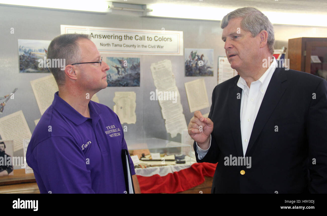 This image captures the ribbon-cutting event for the Iowa Immigration ...