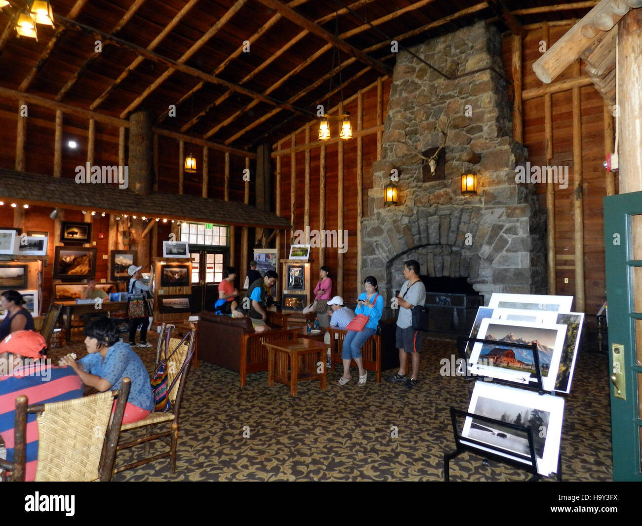 The Old Faithful Lodge lobby features a large stone fireplace, blending ...