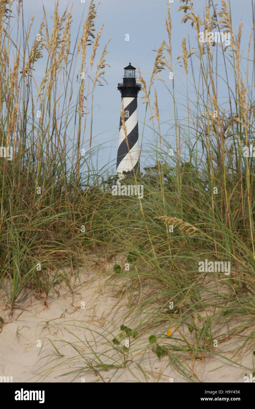 This image captures the iconic Cape Hatteras Lighthouse amidst the sand ...