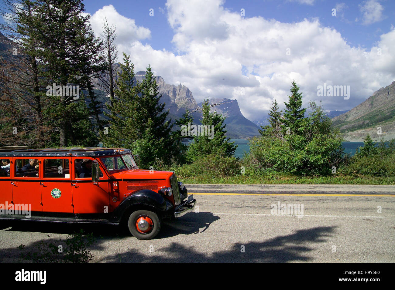 This image showcases the iconic Red Bus in Glacier National Park, a ...