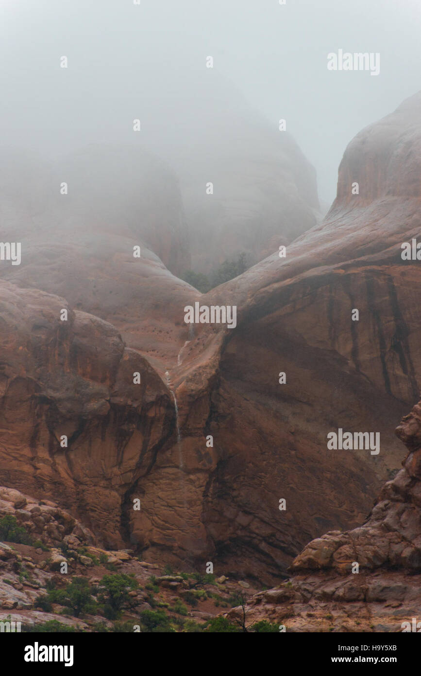 A foggy waterfall in Arches National Park, capturing the park's ...