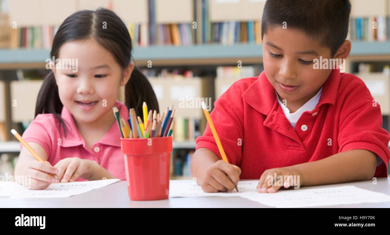 usdagov 22226425095 Two kids writing on paper Stock Photo - Alamy