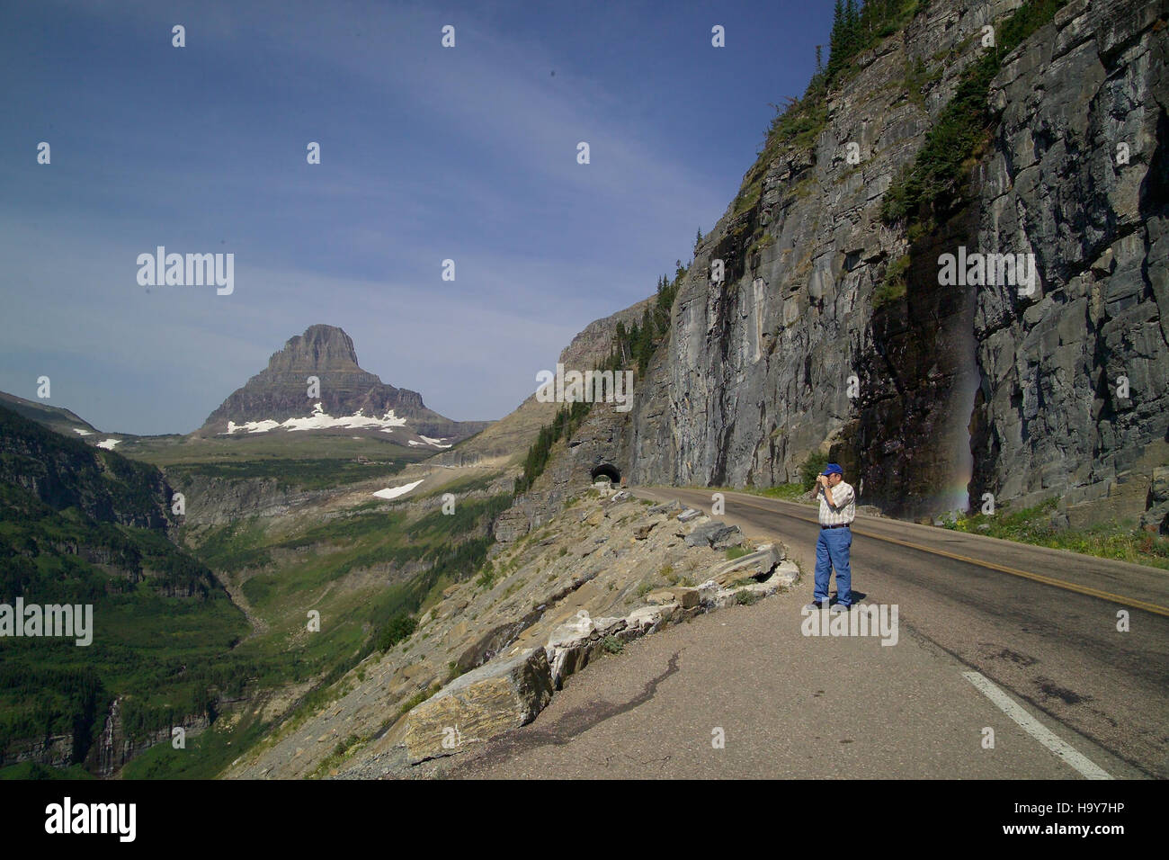 A visitor captures a scenic view while photographing from a road in ...