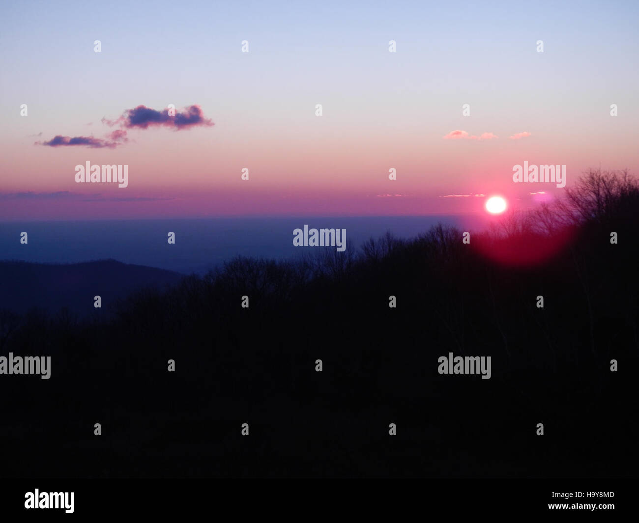 A stunning sunset illuminates the landscape, showcasing nature’s beauty ...