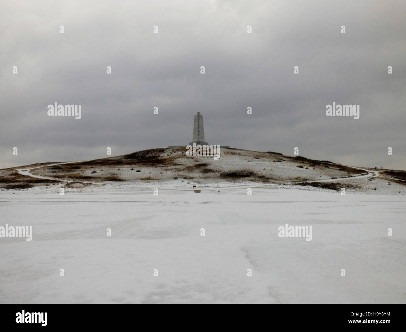 Snow accumulates on the grounds of the Wright Brothers National ...