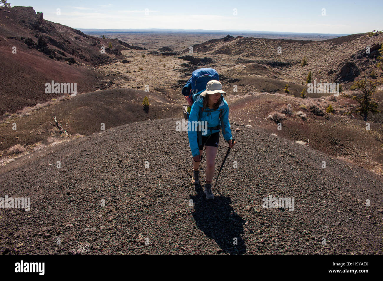 A backpacker ascends the cinder slopes of Craters of the Moon National ...