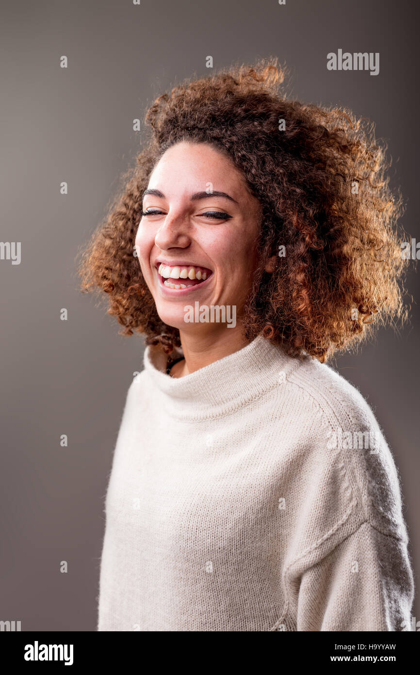 happy curly south-american woman laughter on a dark background Stock ...