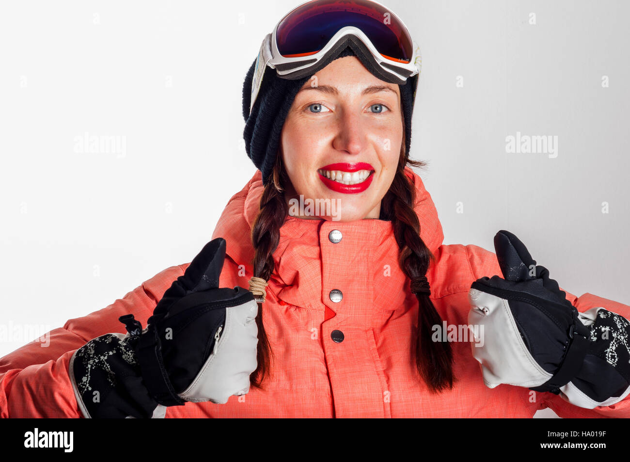 Smiling snowboarding girl with red lipstick Stock Photo - Alamy