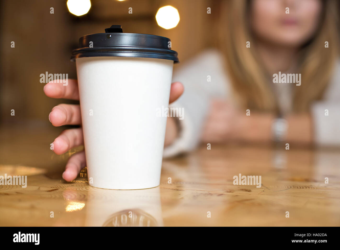 Young charming woman while sitting alone in coffee shop during free ...