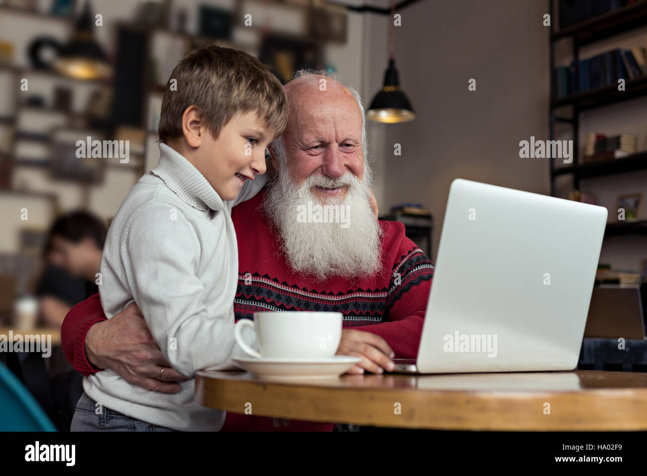 Grandfather and grandson using laptop together Stock Photo - Alamy