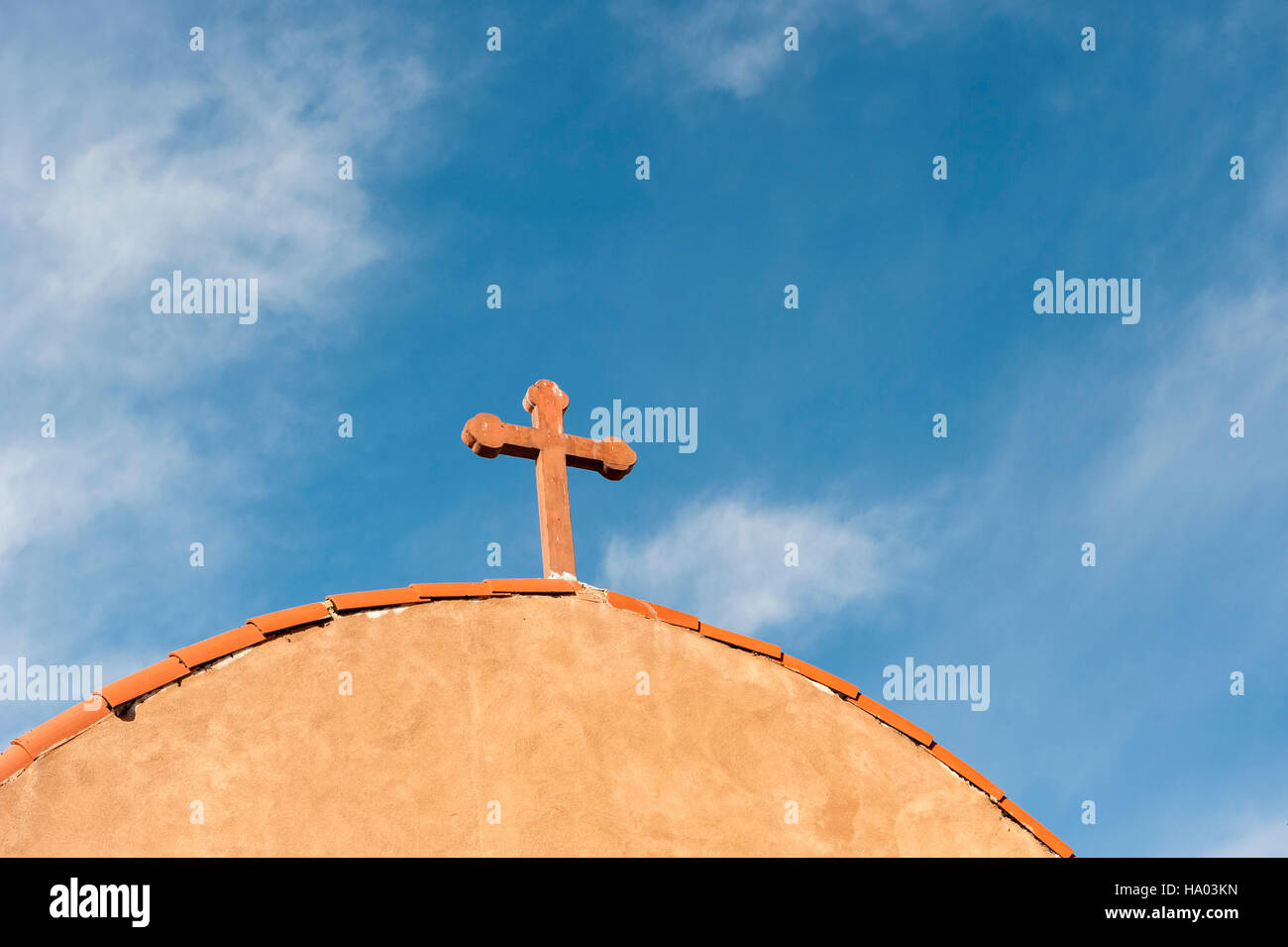 Wood cross, crucifix at the top of a typical adobe style church in San ...