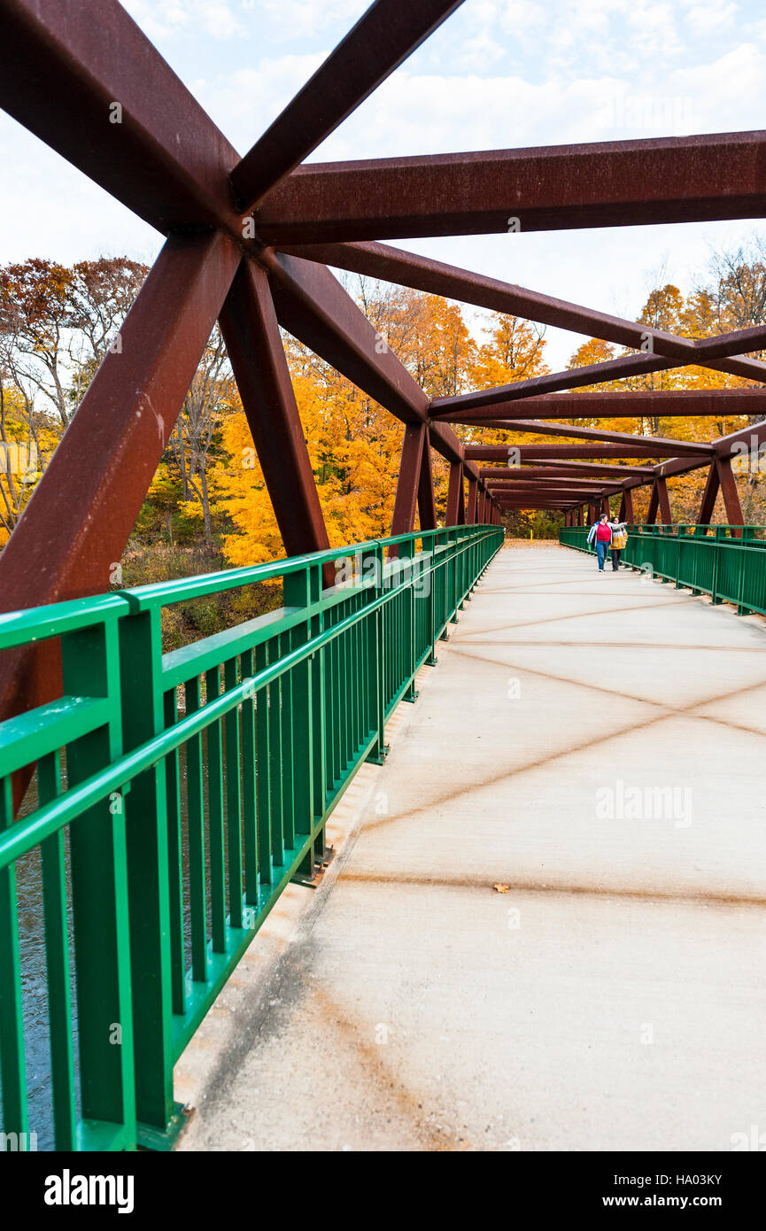 London, Ontario, ON, Canada - Two women crossing a pedestrian bridge ...
