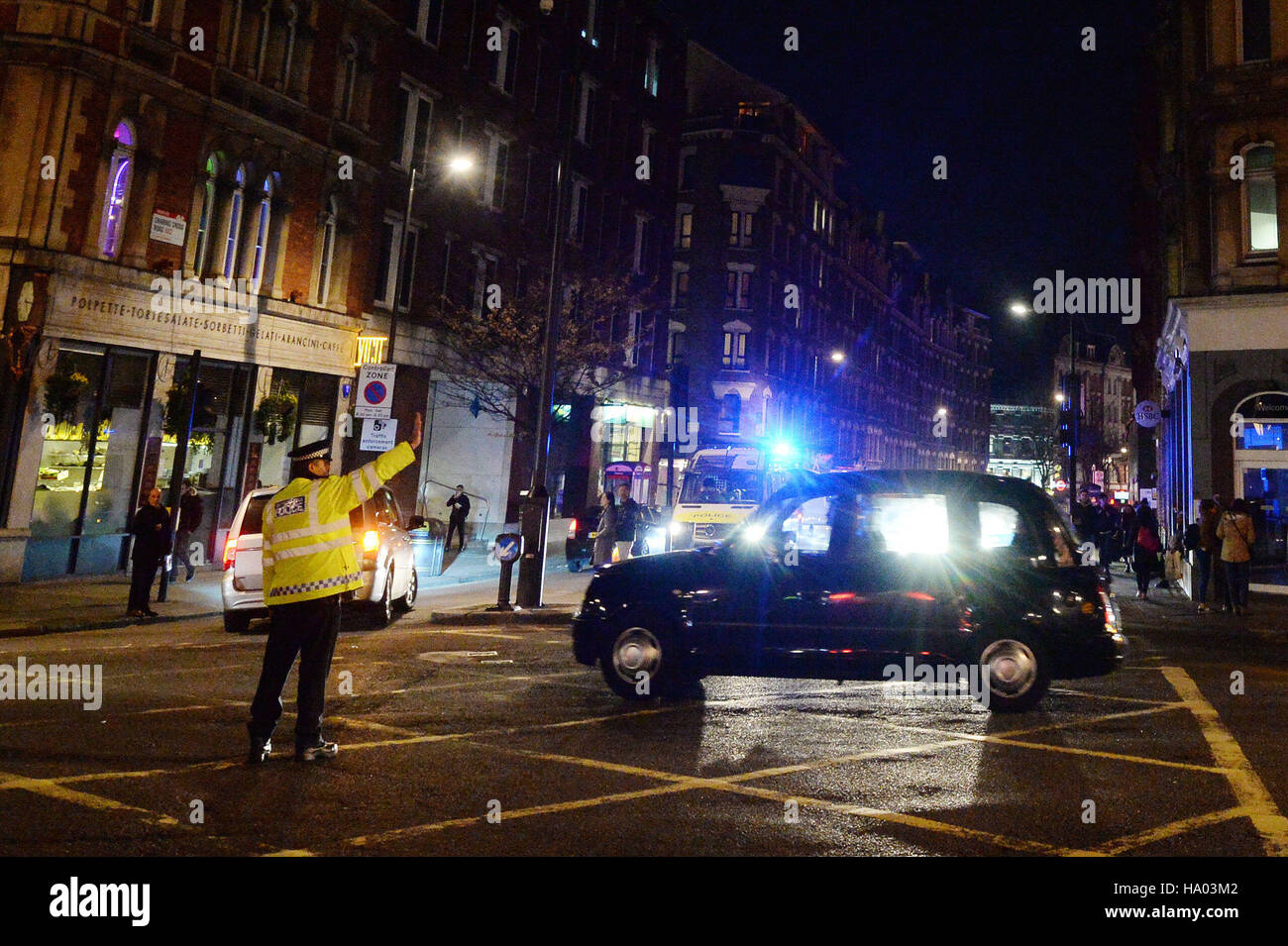Police direct traffic at Cambridge Circus, as a power cut has plunged ...