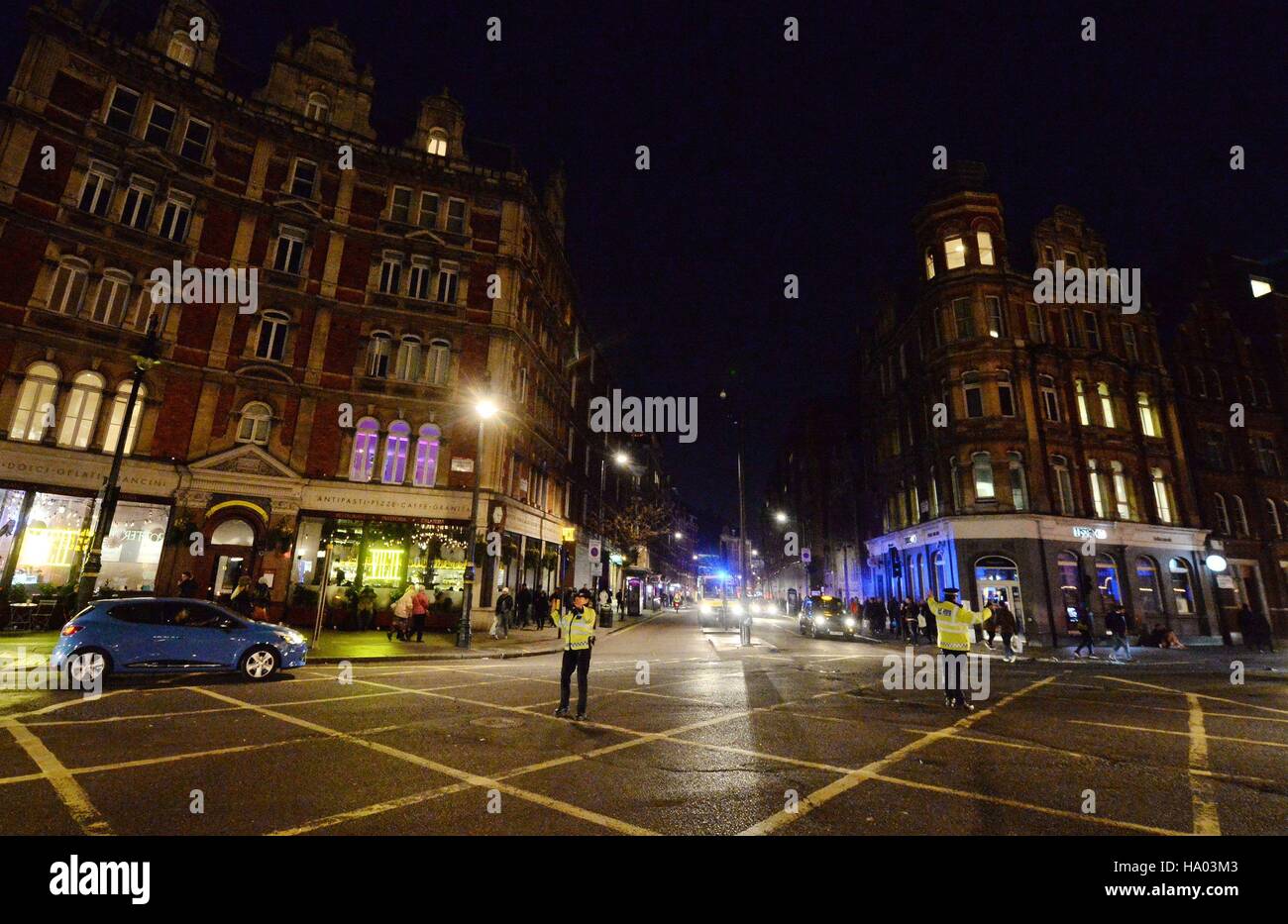 Police direct traffic at Cambridge Circus, as a power cut has plunged ...