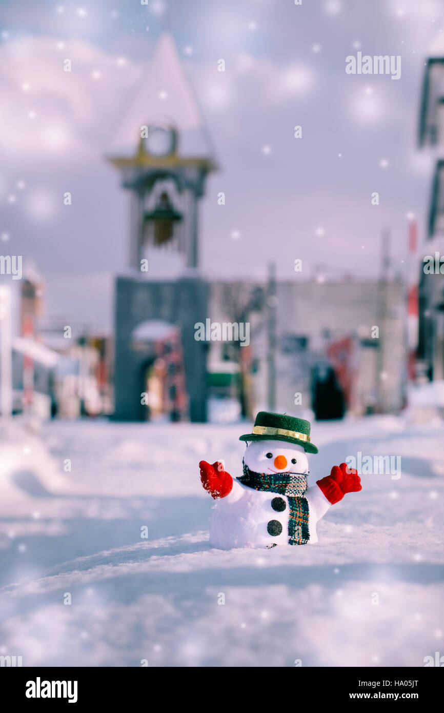 Snowman stand among pile of snow in Biei station. Morning sunshine is ...