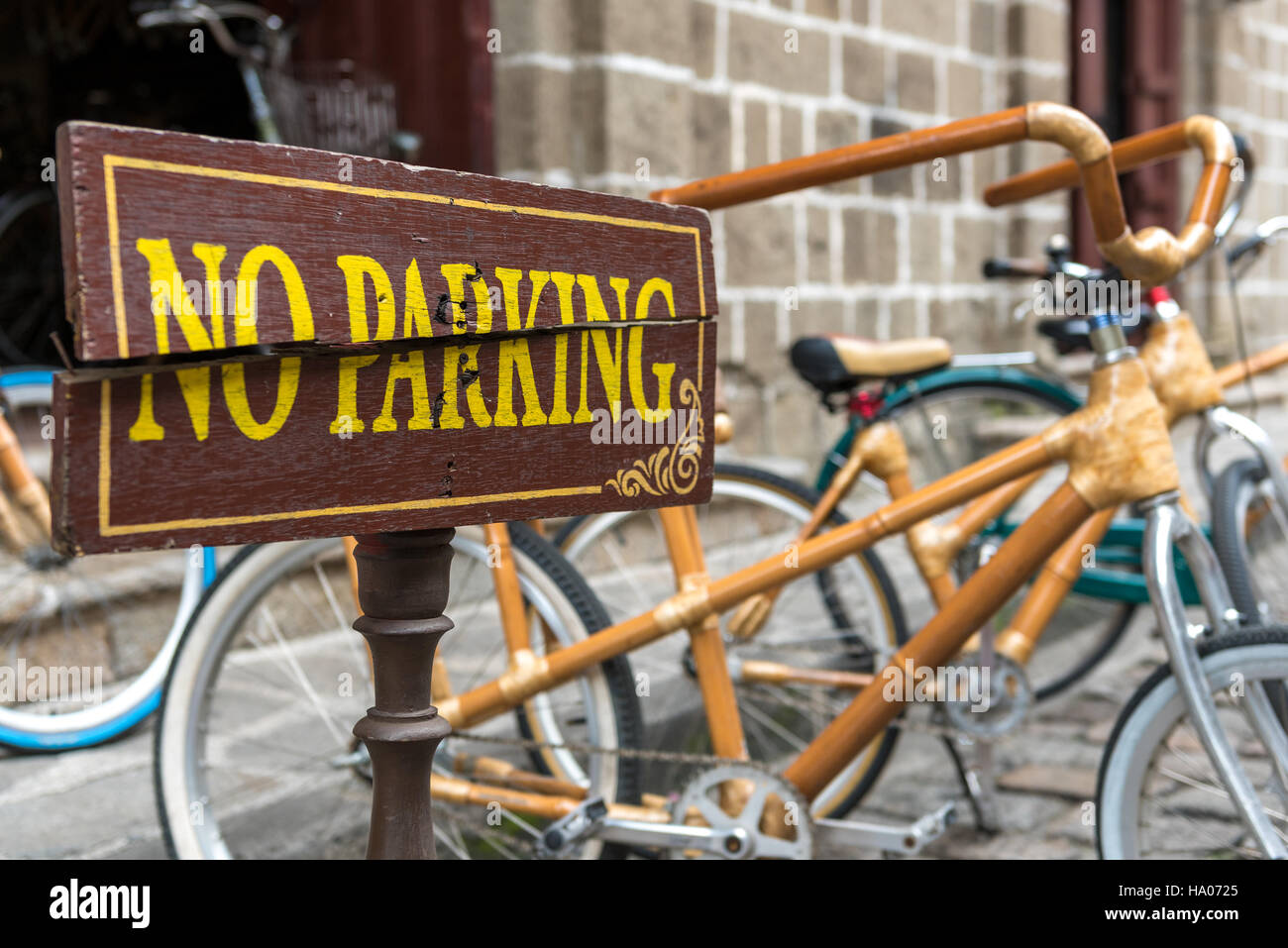 No Parking. Cracked 'no parking' sign in front of bamboo and steel ...