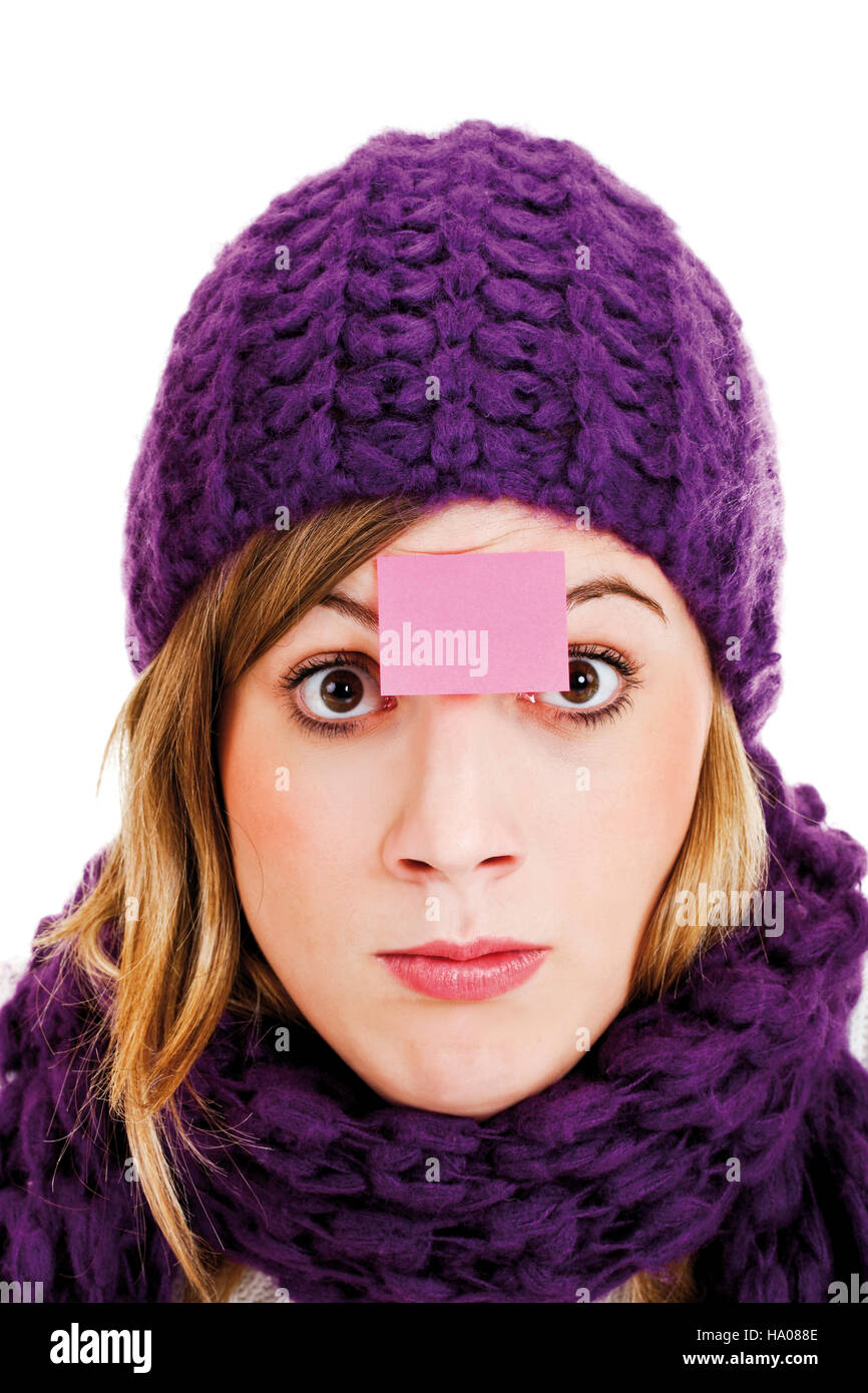 Young woman wearing a purple woolen cap and scarf with a post-it note ...