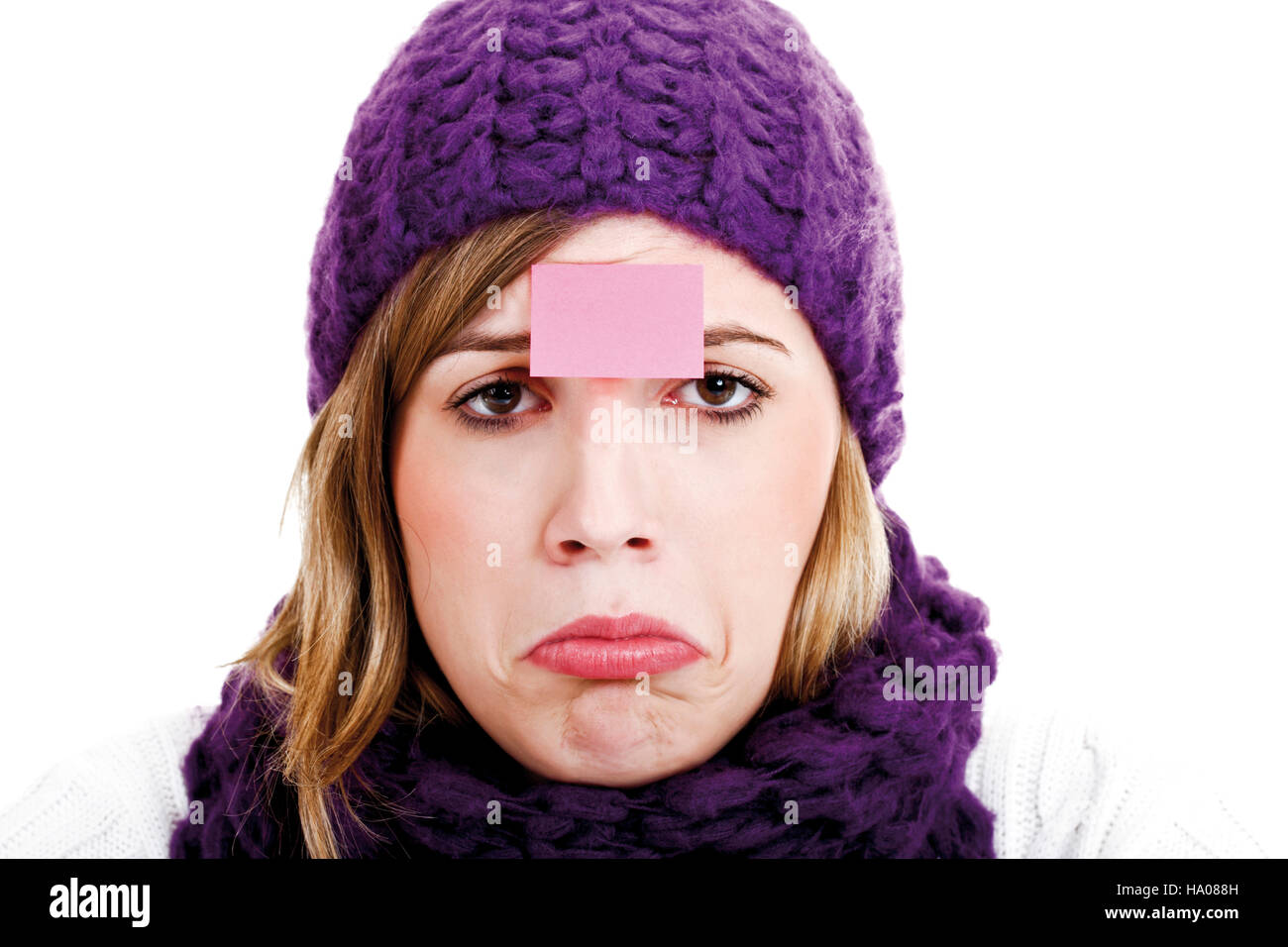 Young woman wearing a purple woolen cap and scarf with a post-it note ...