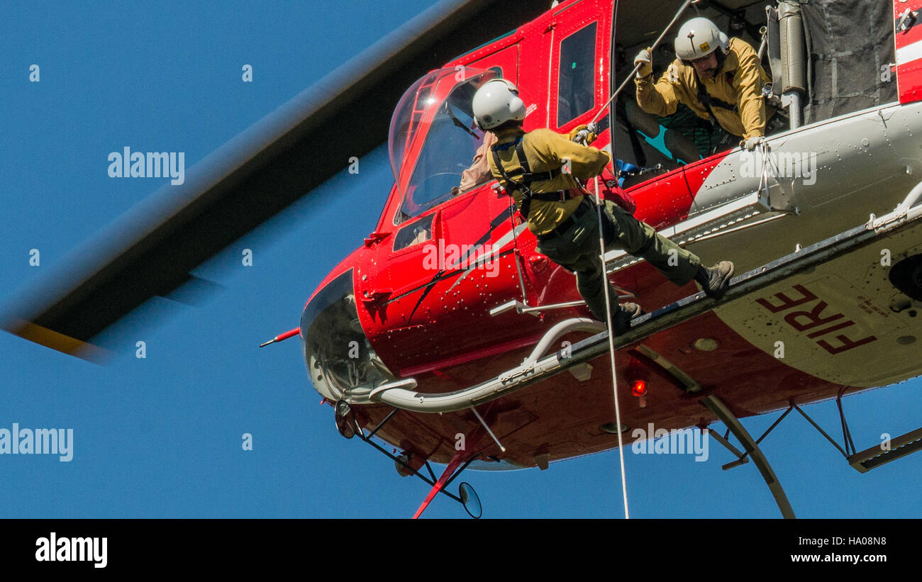 A USDA Forest Service wildland firefighter participating in rope rappel ...