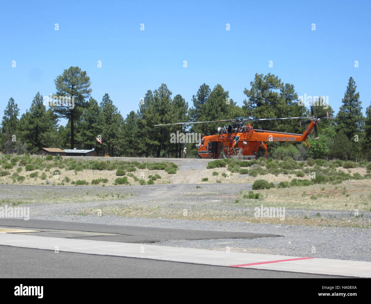 A fire helicopter in action, assisting with wildfire control efforts ...