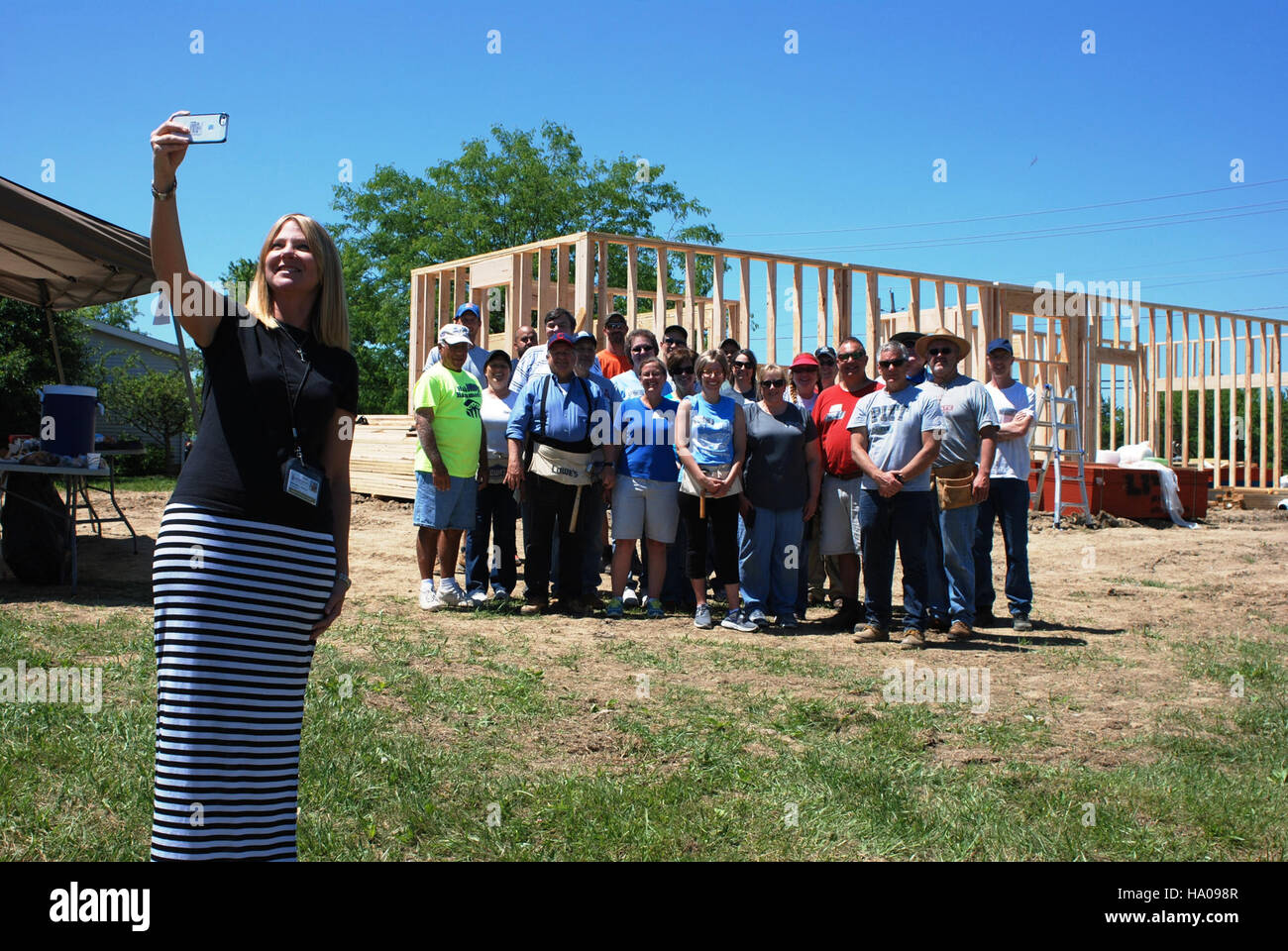 Michelle Amrine, a homeowner, is photographed with a crew helping build ...