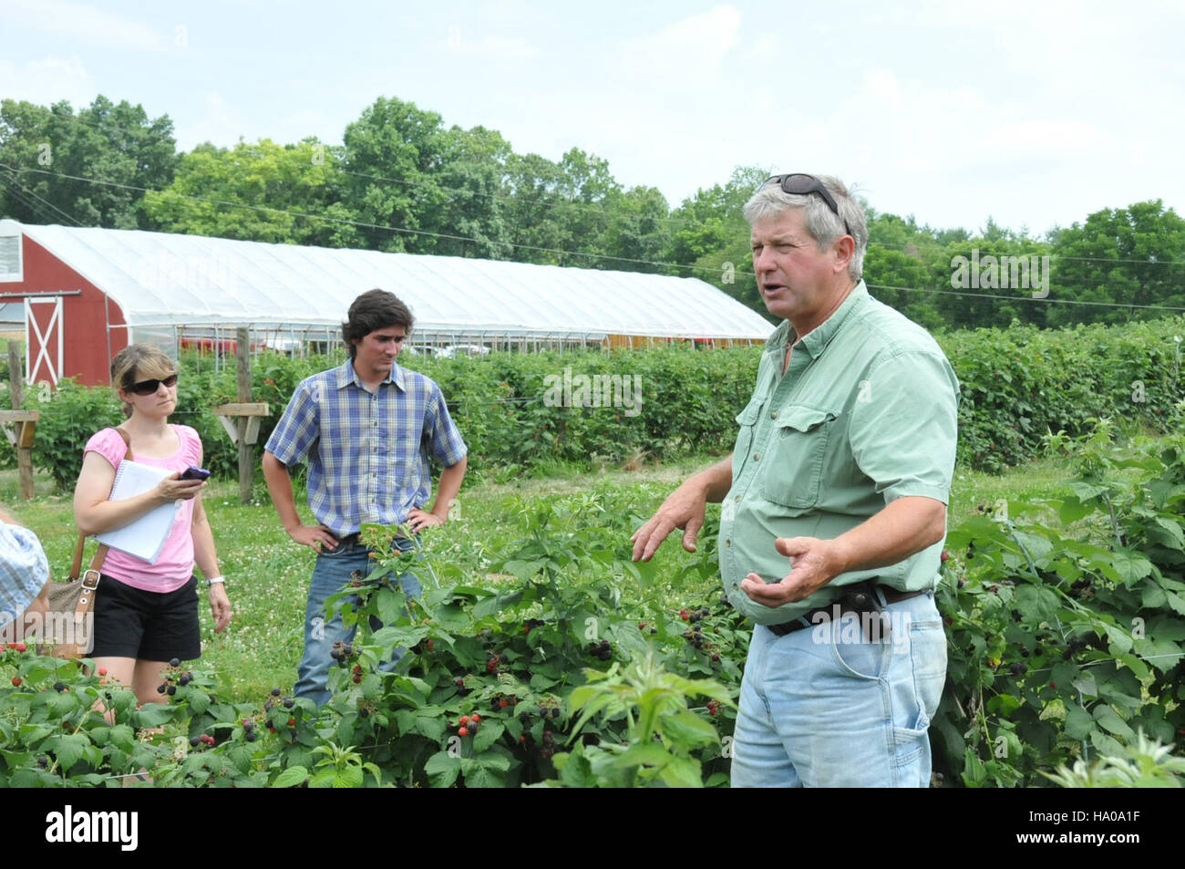 Wade Butler demonstrates the use of a drip irrigation system to ...
