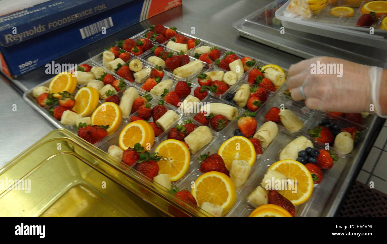 This image shows fruits arranged in plastic trays, likely for ...