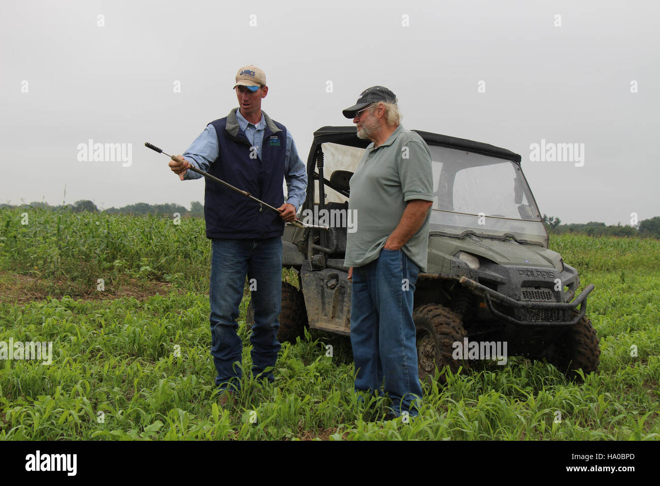 A USDA NRCS employee collaborates with a farmer to implement ...