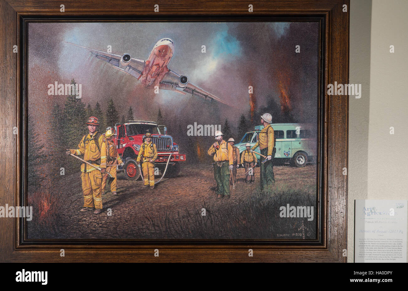 An employee of the USDA showcases their artwork in a display organized ...