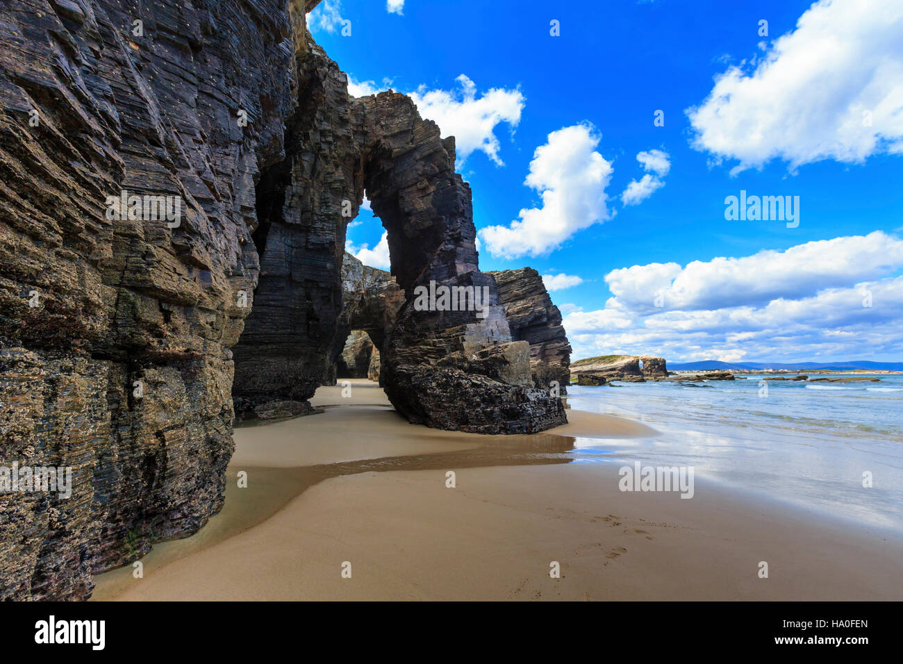 Natural rock arches on Cathedrals beach in low tide (Cantabric coast ...
