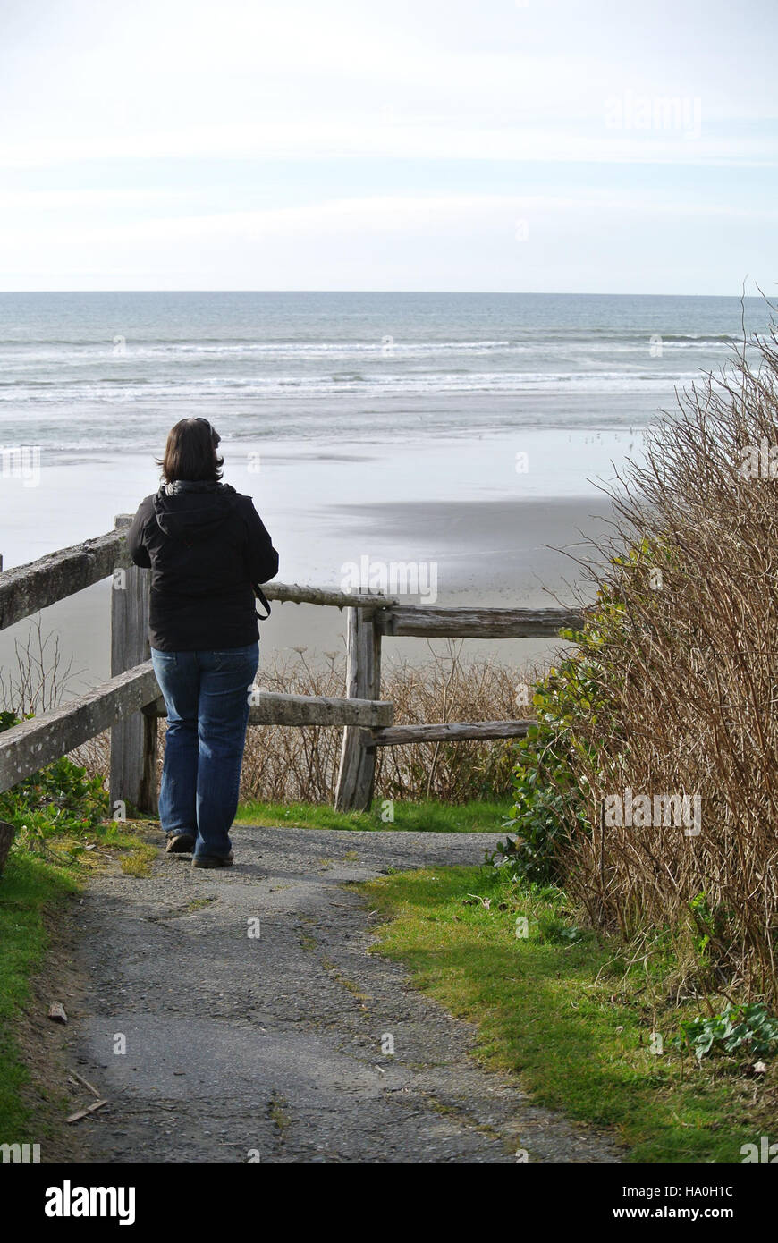 This image features visitors walking along a beach access trail at ...