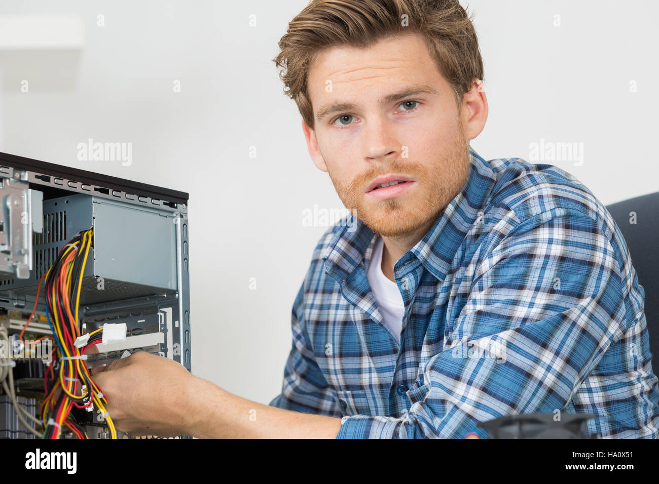 young man fixing computer Stock Photo - Alamy