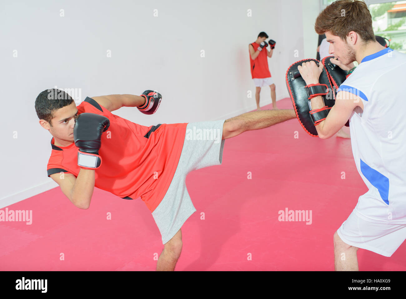 Young man kick boxing Stock Photo - Alamy